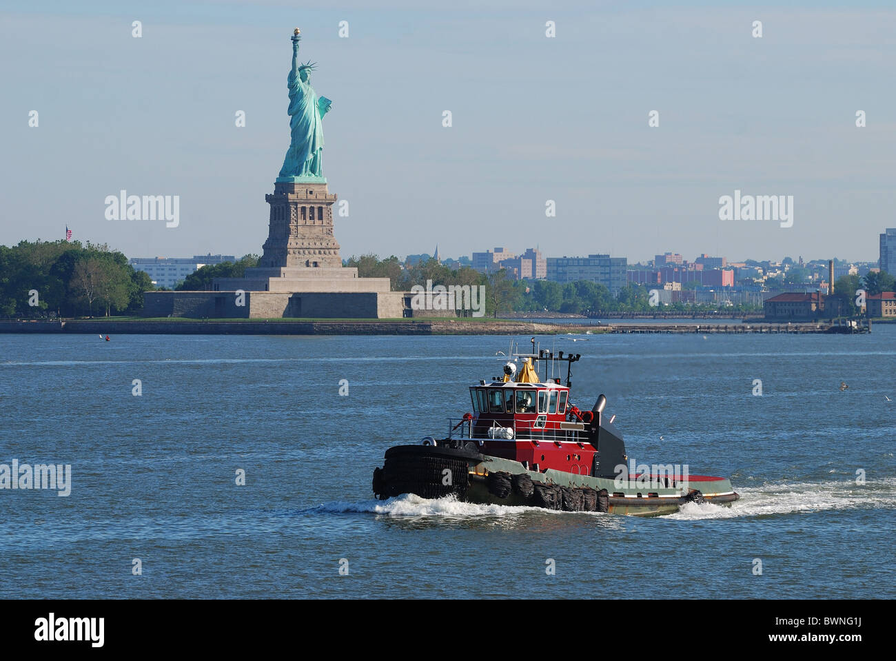 Boat pass by Statue of Liberty in New York City Manhattan Hudson River ...