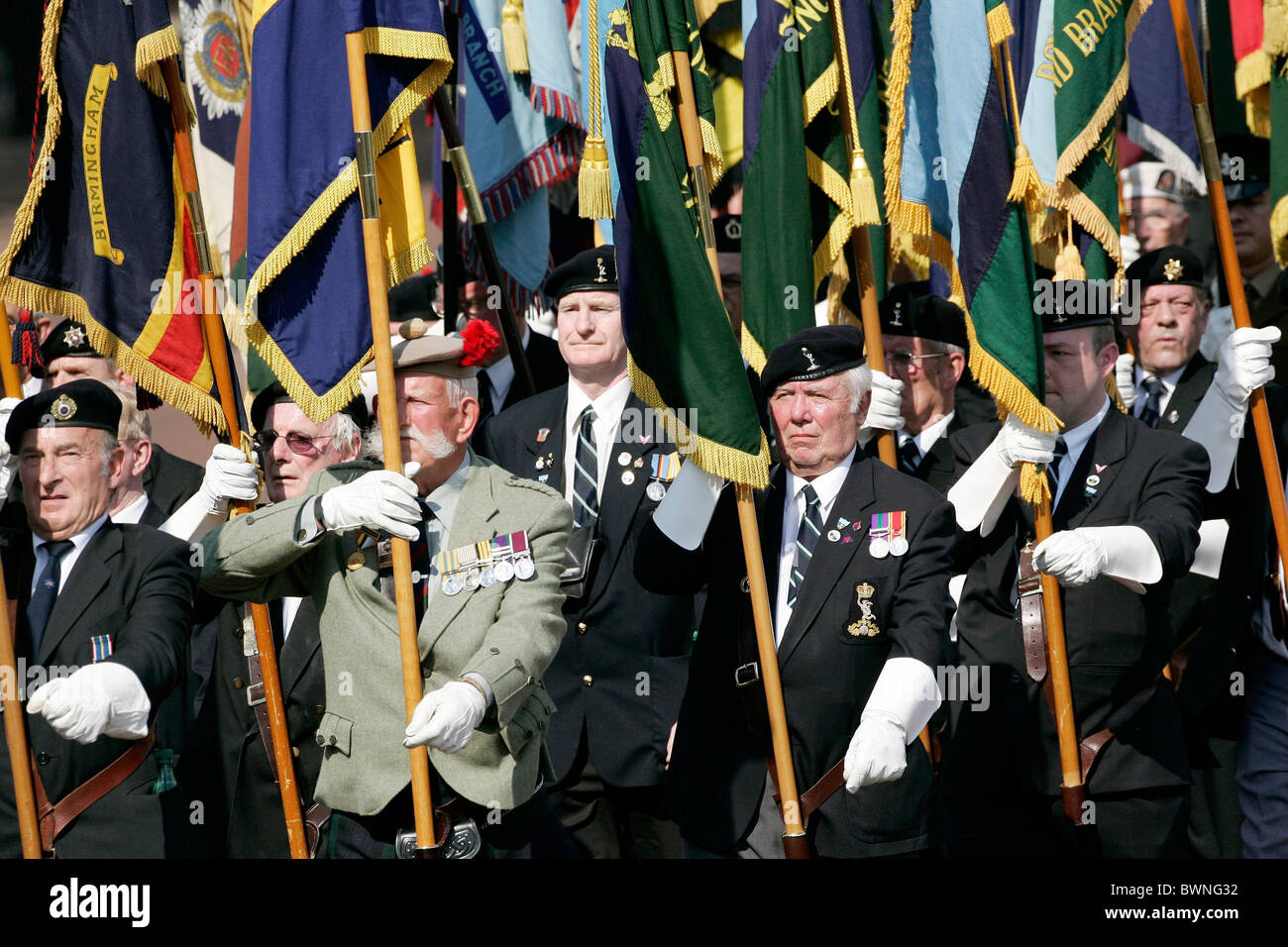 Veterans carrying regimental flags in parade along the Mall after ...