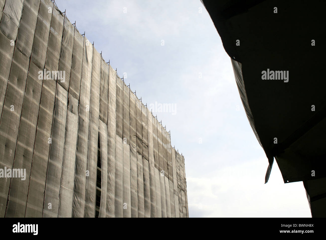 protective mesh cover on building being renovated Stock Photo - Alamy