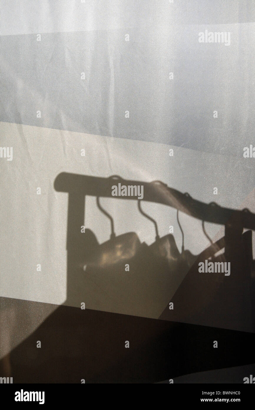 shadow of clothes on rail in street market Stock Photo - Alamy