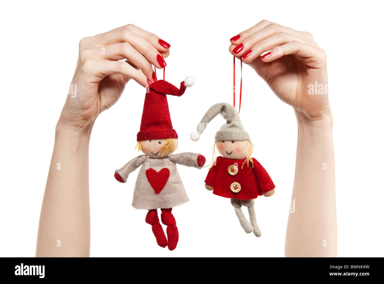 Studio photo of woman's hands playing with puppets. Pair of dwarves on ...