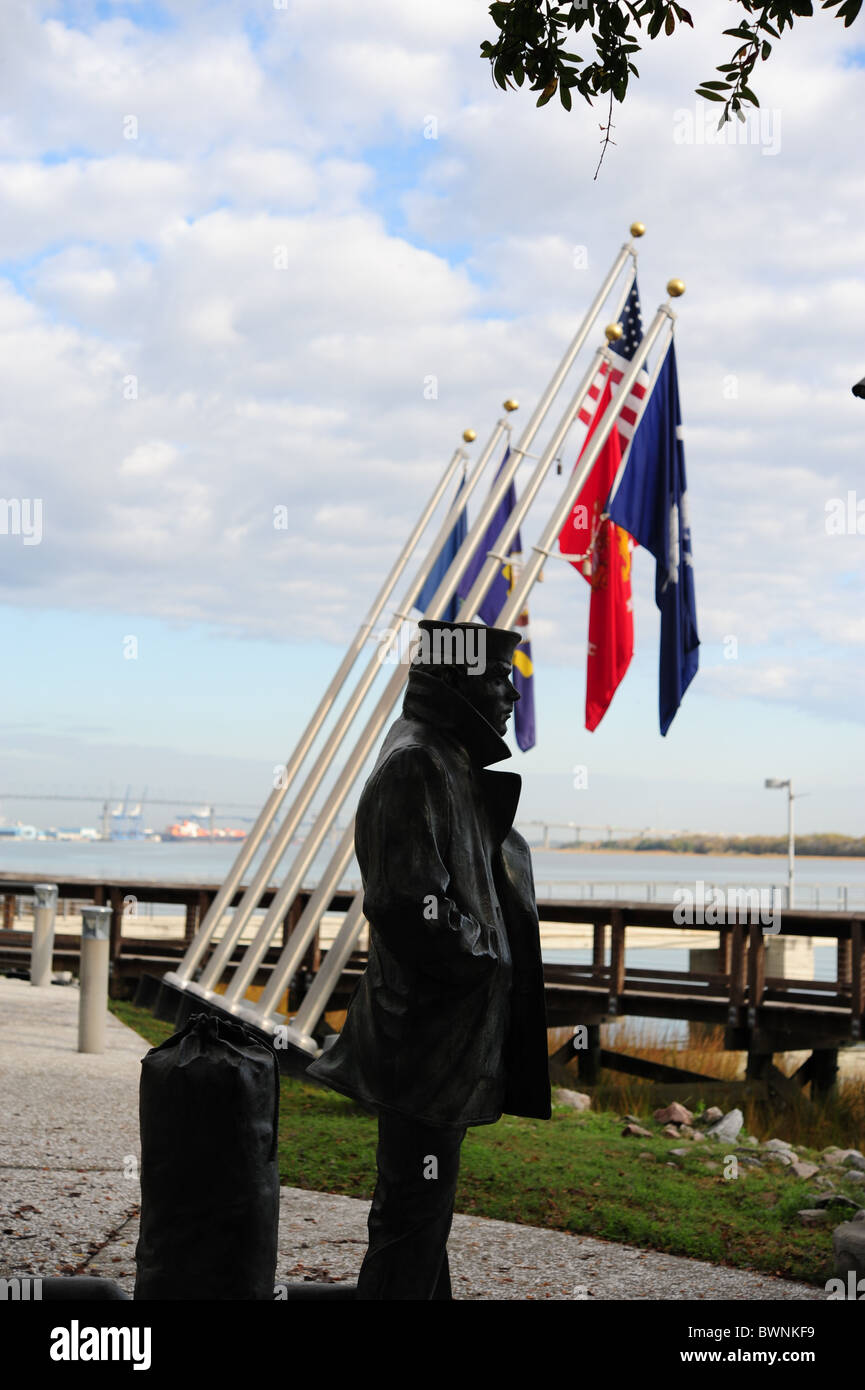 Navy memorial flags with statue of sailor gazing at Cooper river Stock ...