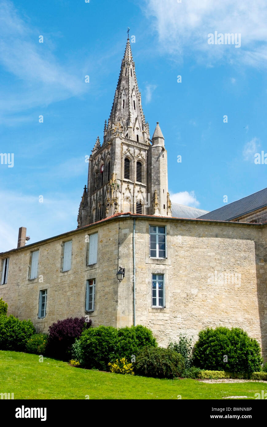 A church spire towering over an out building Stock Photo - Alamy