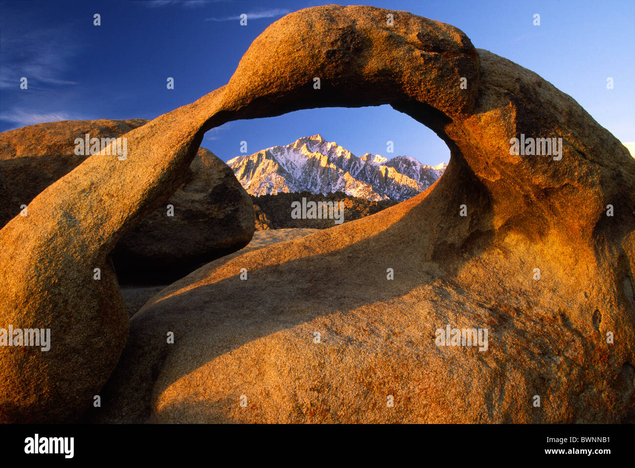 Granite arch in California's Alabama Hills with the Sierra Nevada range ...