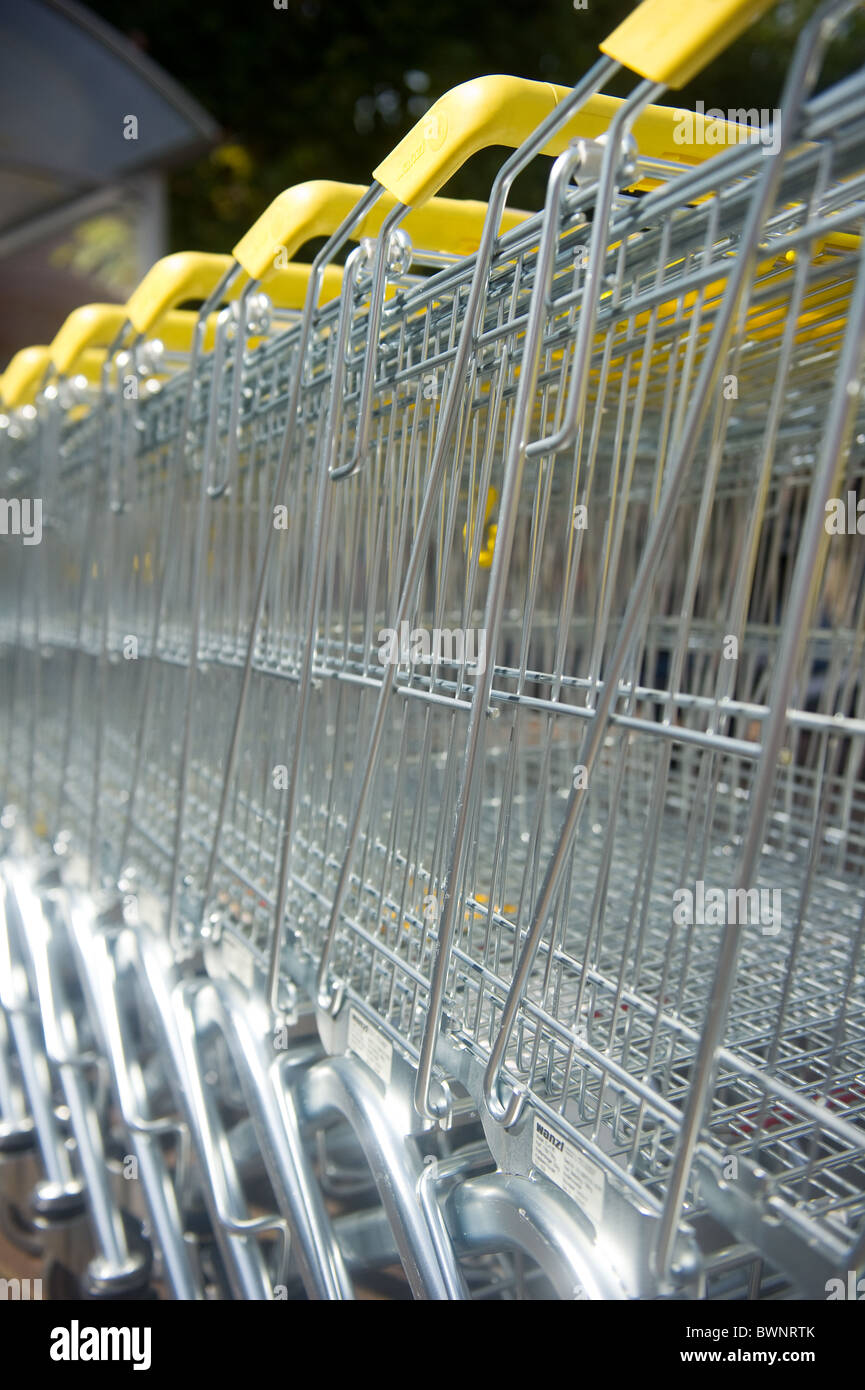 Many metal shopping carts with yellow handles outdoor Stock Photo - Alamy
