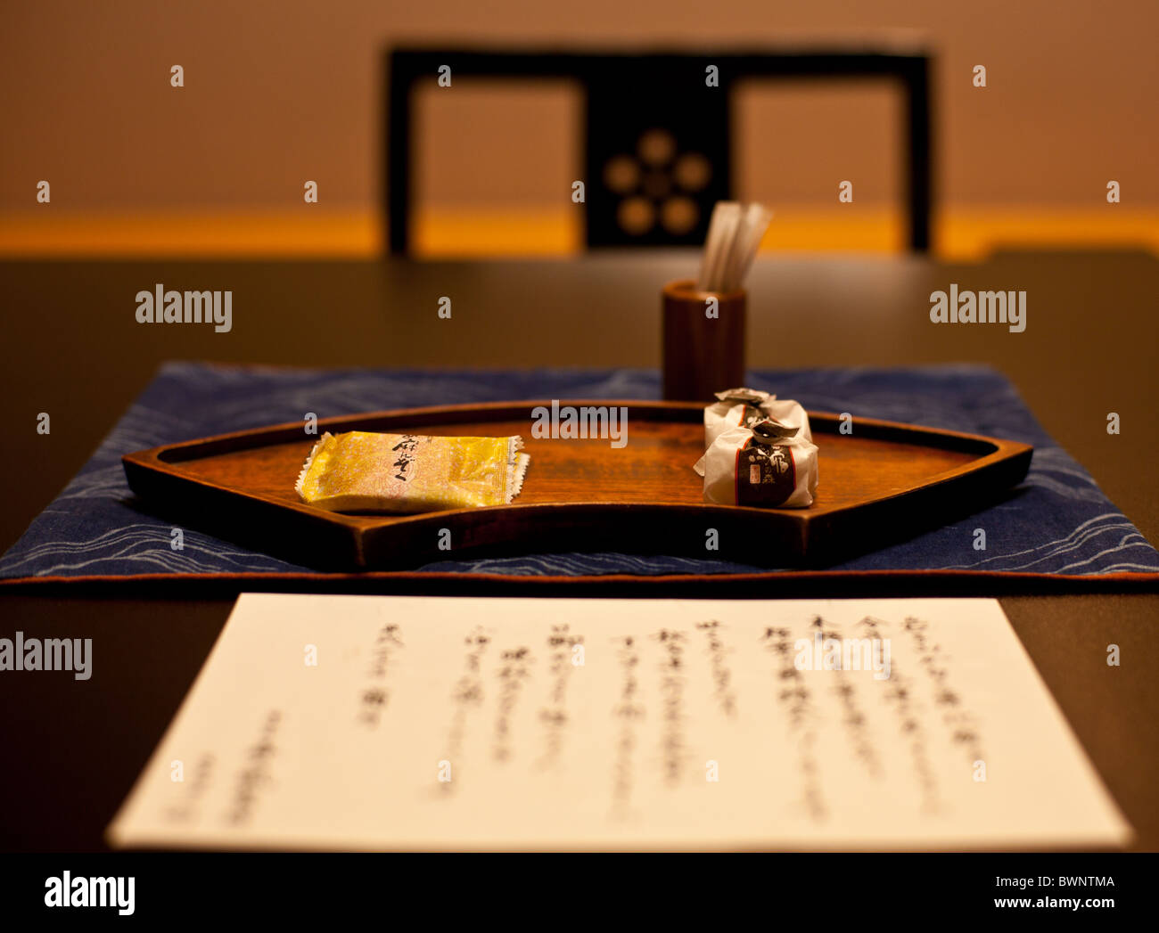 An elegant Japanese table setup with menu and Japanese sweets, commonly ...