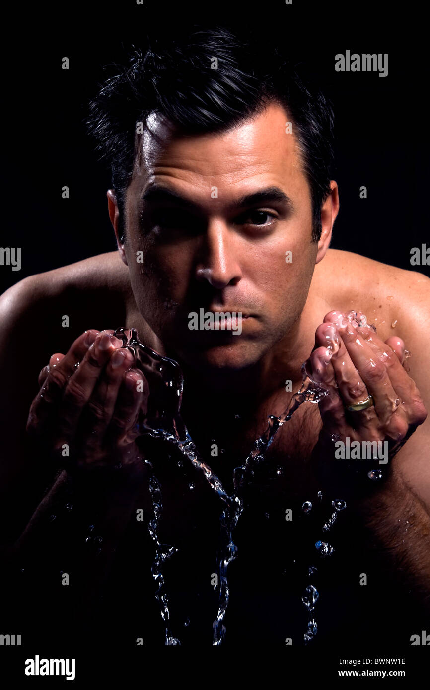 Handsome male washing his face to wake up in the morning Stock Photo ...