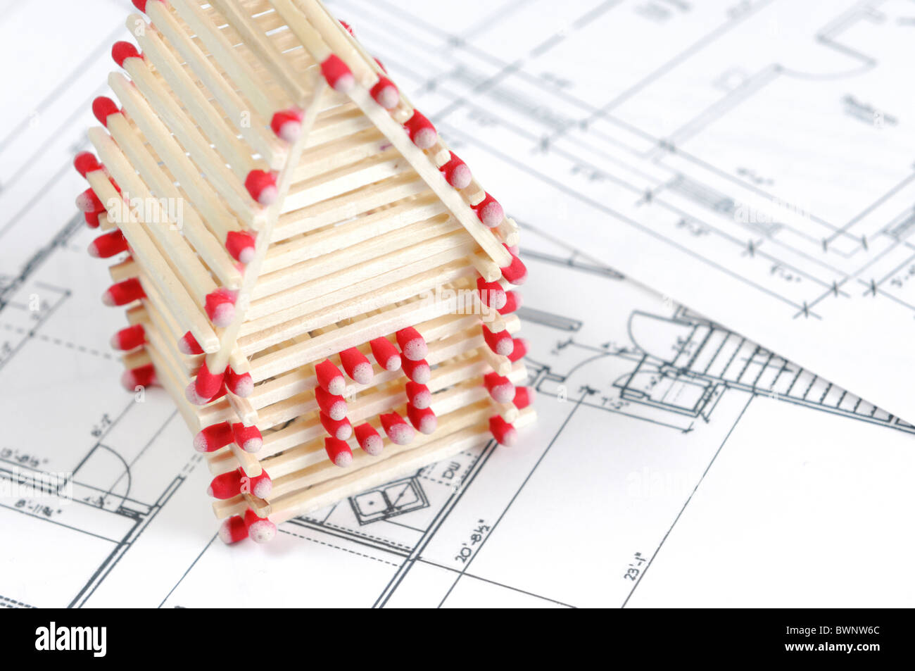 House made from matches standing on construction plans Construction ...