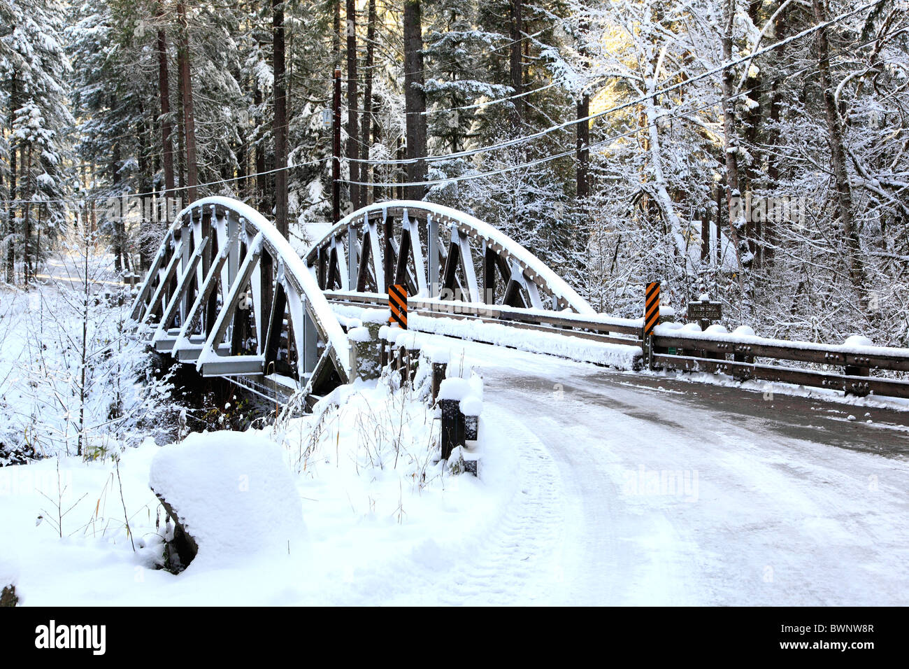 An old arch bridge covered in snow Stock Photo - Alamy