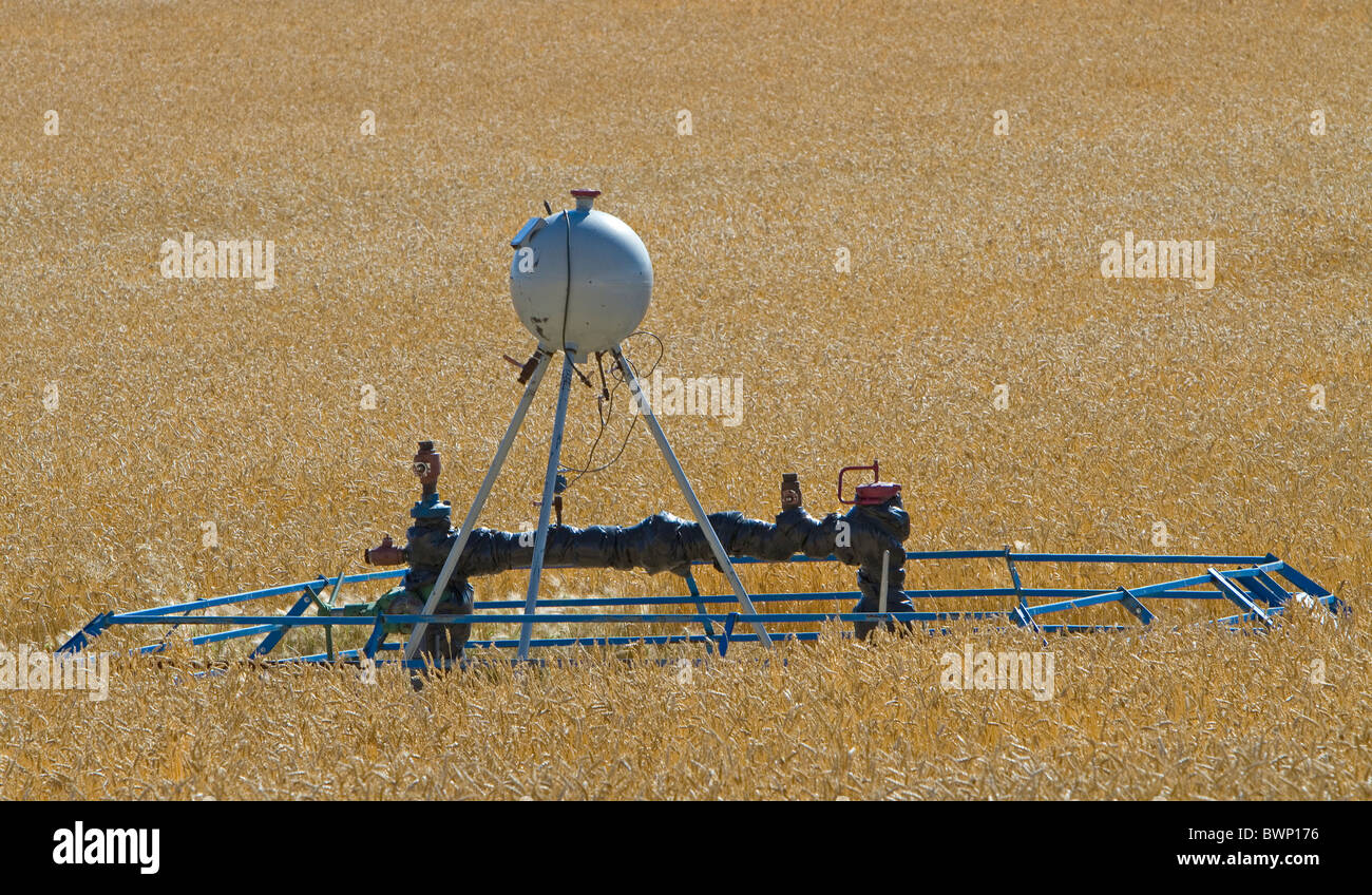 natural gas well head with methanol tank surrounded by cattle fence ...