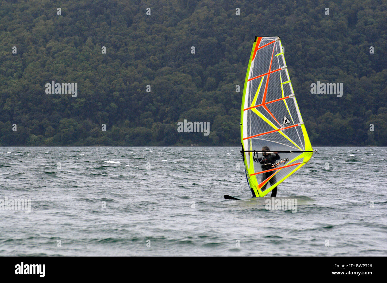 Man practising windsurf in a volcanic lake, winter season Stock Photo ...