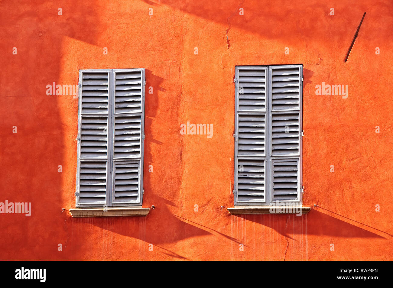 white windows in orange wall Stock Photo - Alamy