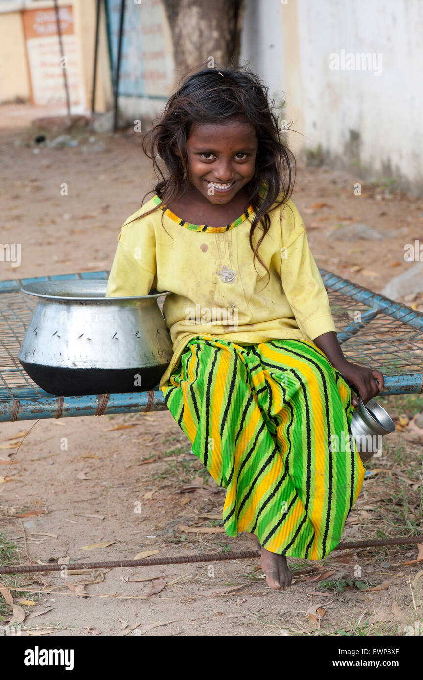 Happy young poor lower caste Indian street girl smiling, sitting on a ...