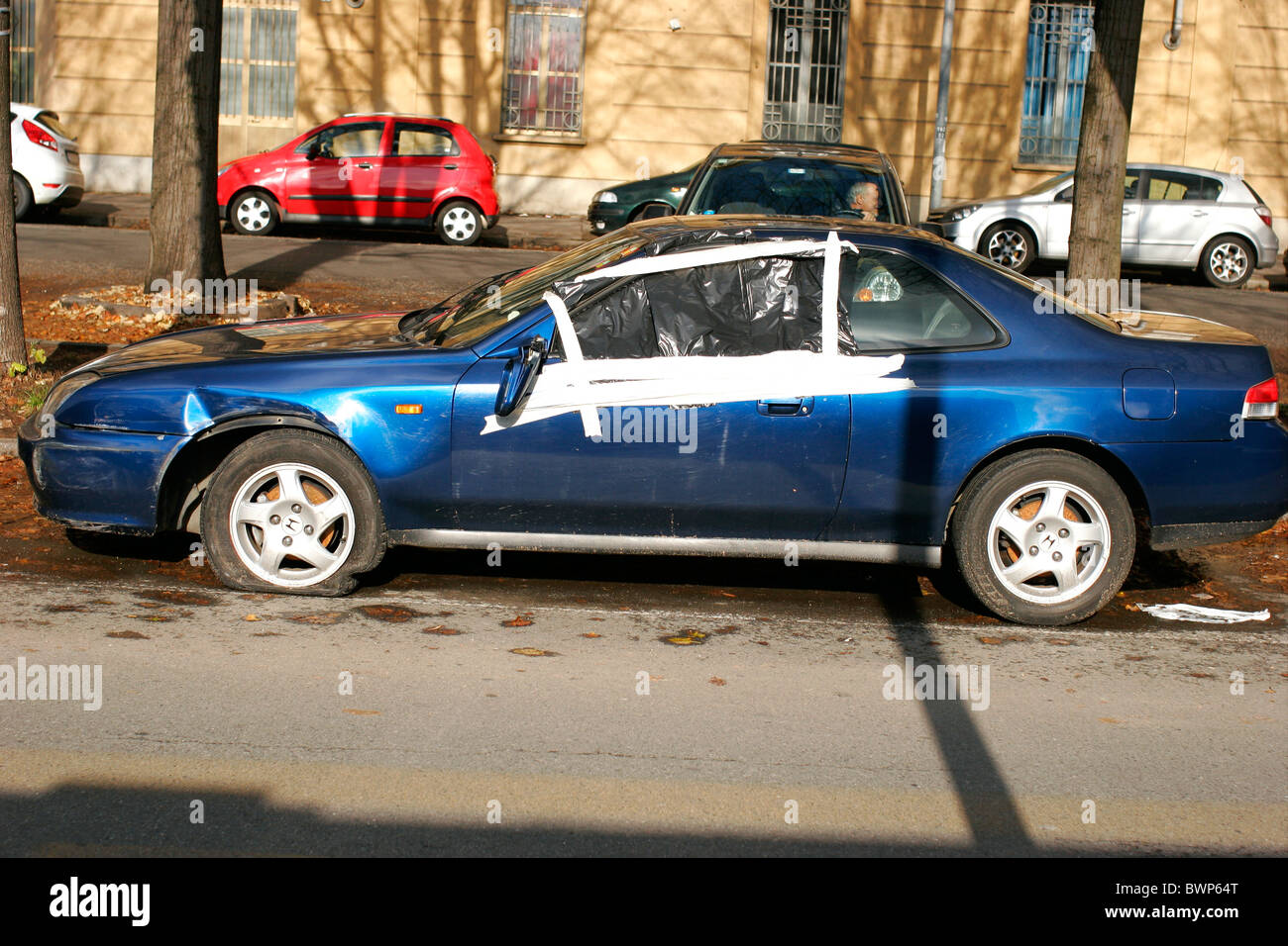 Vandalized car in Italy Stock Photo - Alamy