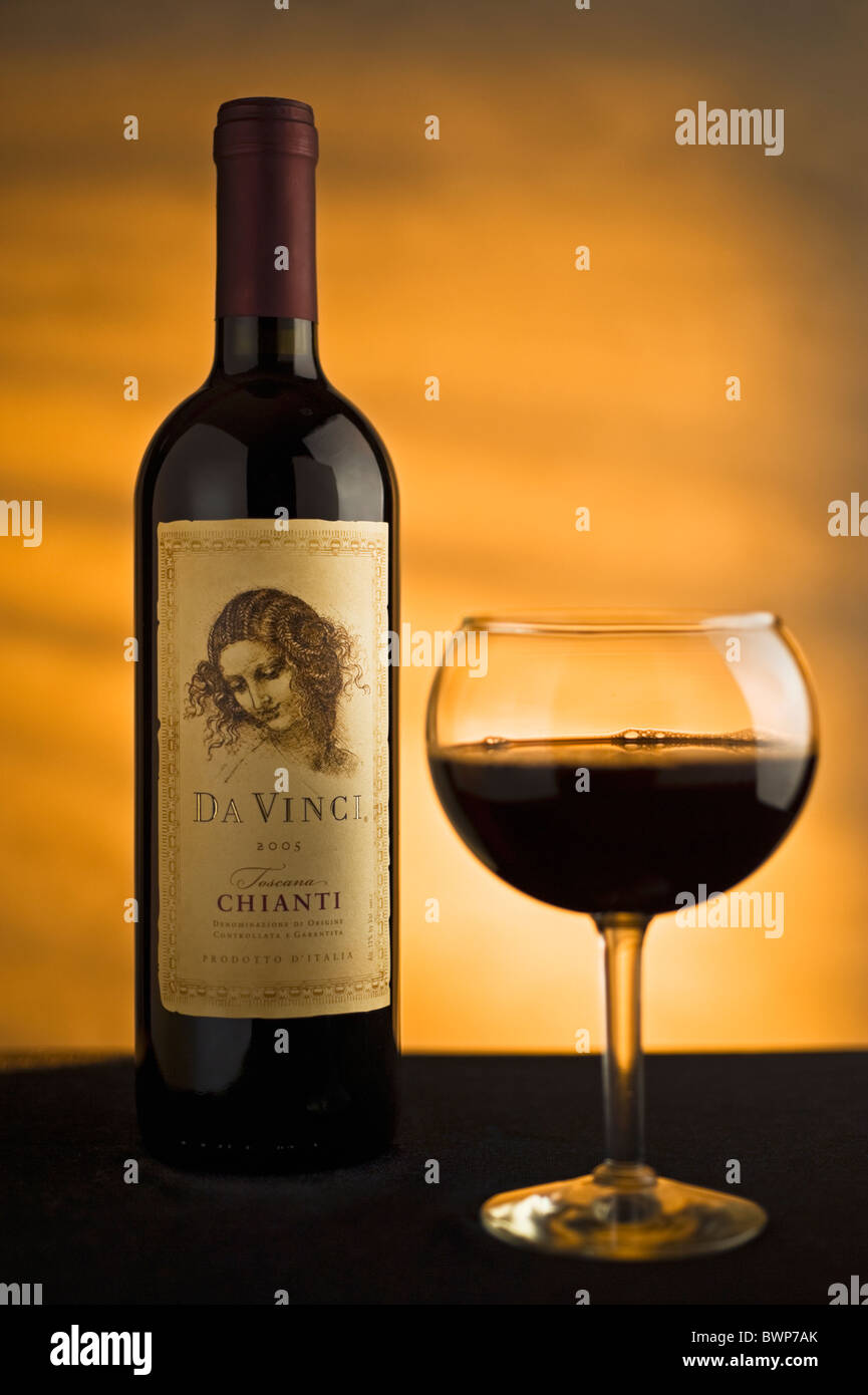 Da Vinci Chianti wine glass and bottle with a warm glow in the ...