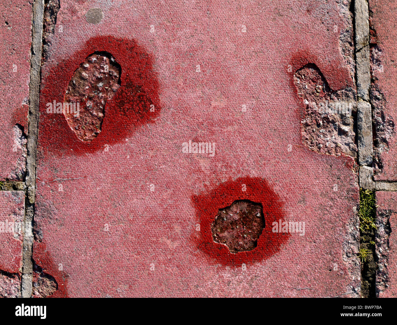 Blood red water stains on pavement Cornwall UK Stock Photo - Alamy