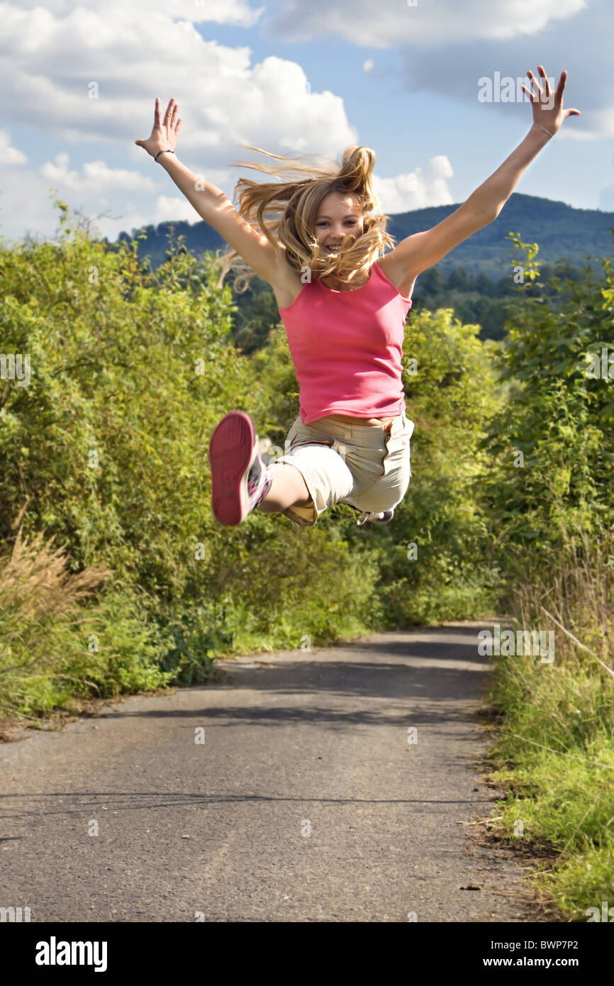 beautiful girl jump on way Stock Photo - Alamy