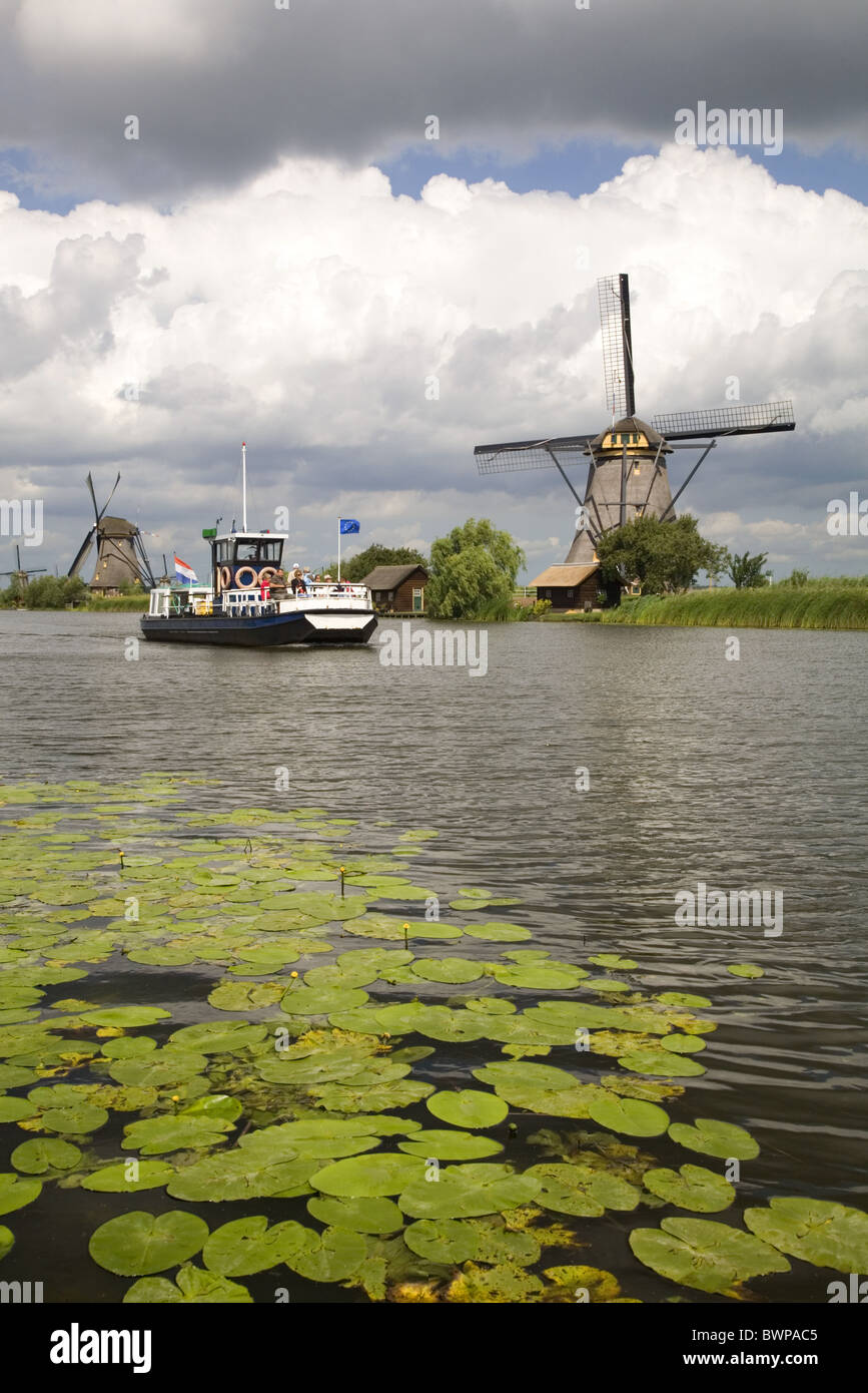 Windmill and tourist boat of the Unesco World Heritage Site Kinderdijk ...