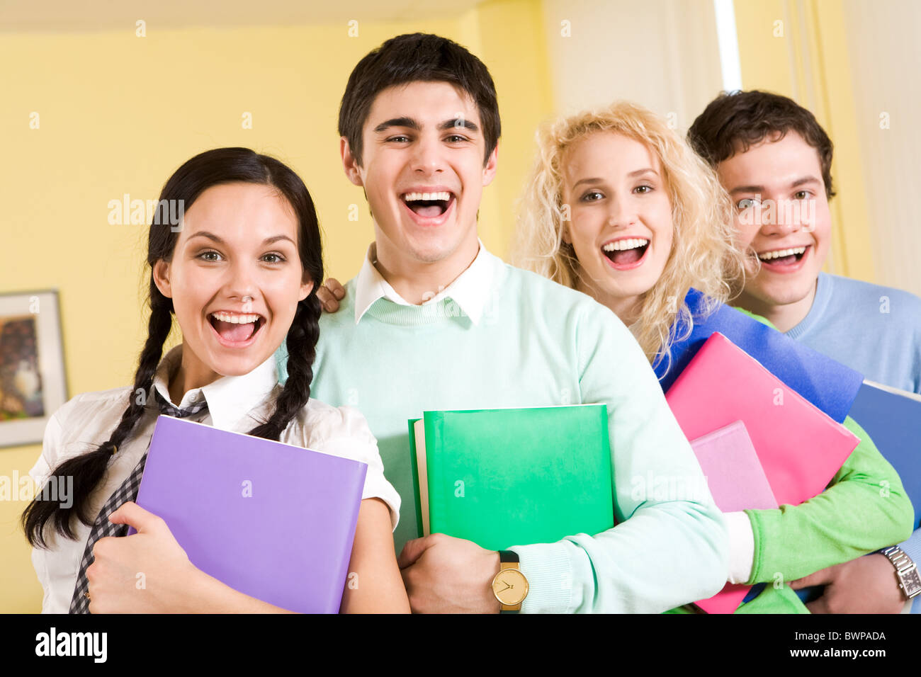 Portrait of happy students laughing next to each other Stock Photo - Alamy