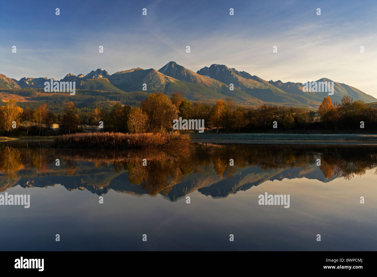 Mist hanging on Tatranska Strbsa lake below the High Tatra mountains in ...