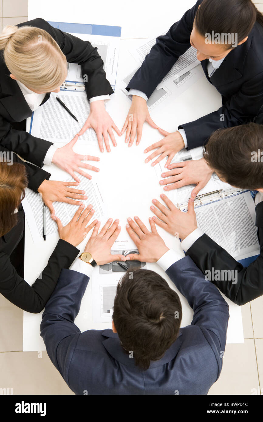 Above view of business partners making circle from hands on table Stock ...