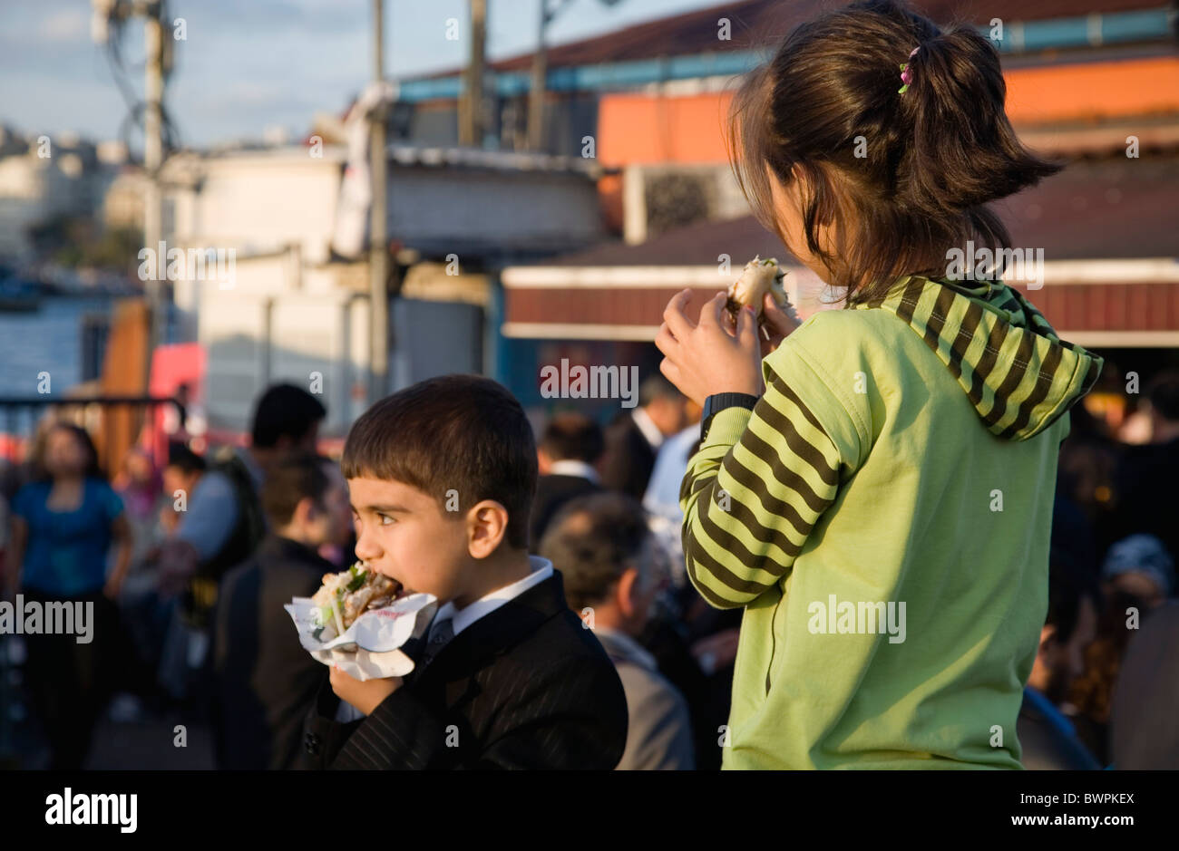 TURKEY Istanbul Sultanahmet Turkish boy and girl eating grilled fresh ...