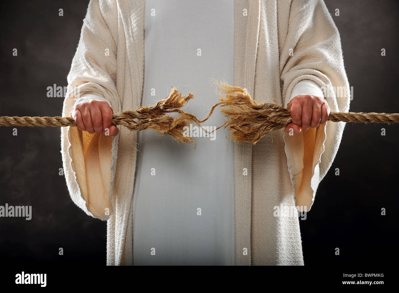 Jesus hands holding frayed rope over dark background Stock Photo - Alamy