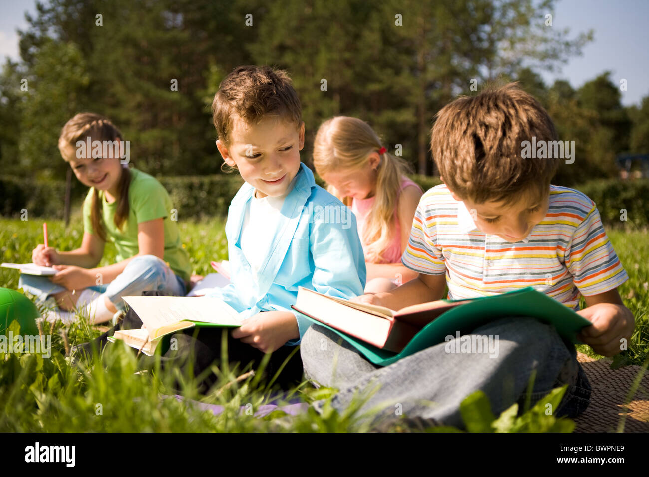 Portrait Of Cute Kids Reading Books In Natural Environment Together Stock Photo Alamy portrait-of-cute-kids-reading-books-in-natural-environment-together-stock-photo-alamy