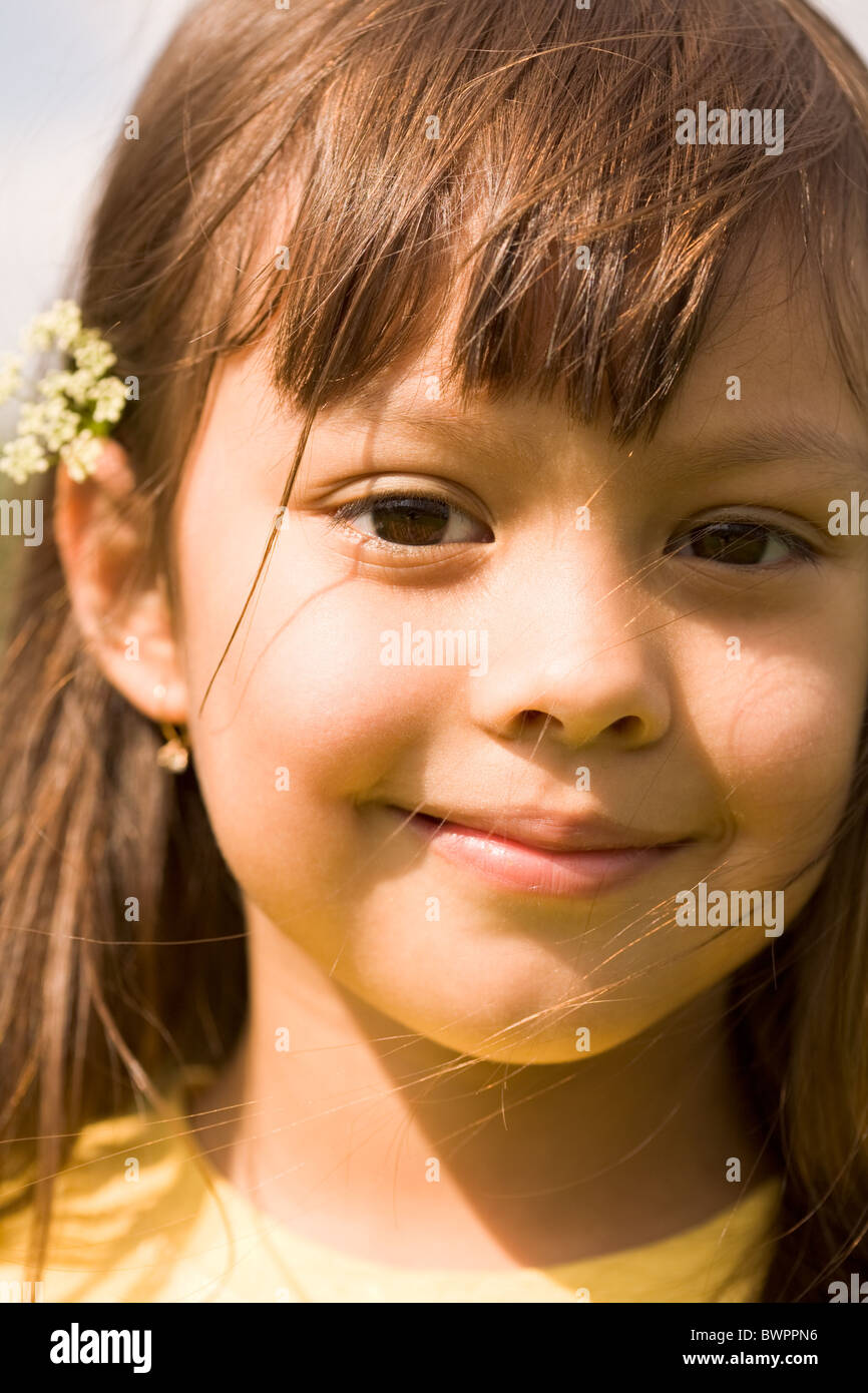 Portrait of cute girl looking at camera and smiling Stock Photo - Alamy
