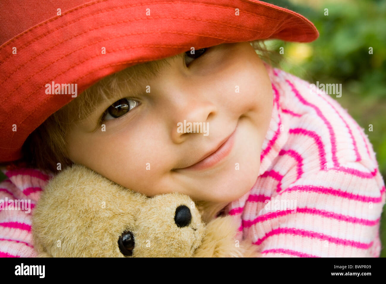Head of girlie embracing her teddy-bear with peaceful expression Stock ...