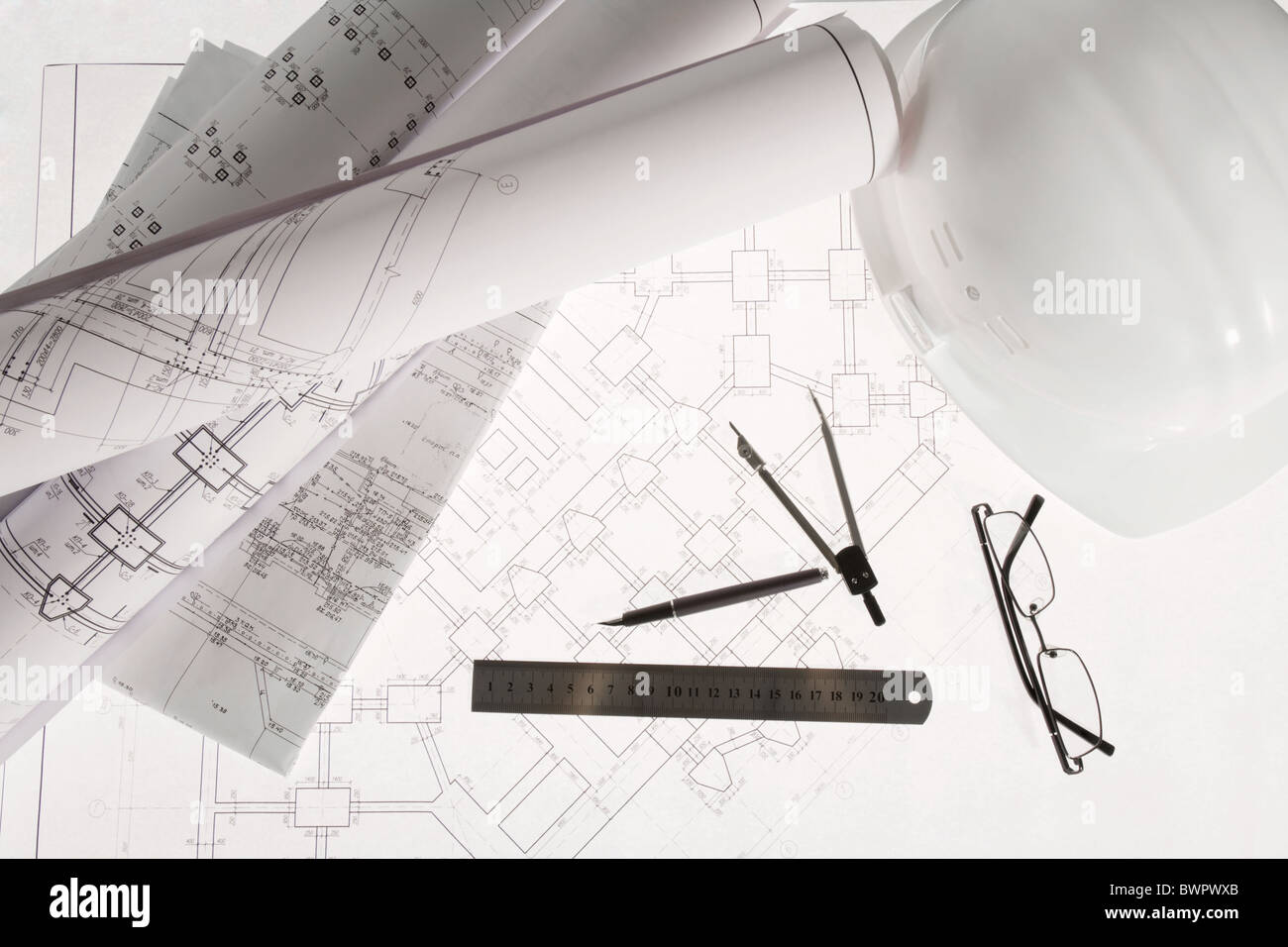 Close-up of blueprints with sketches of projects, eyeglasses, helmet ...