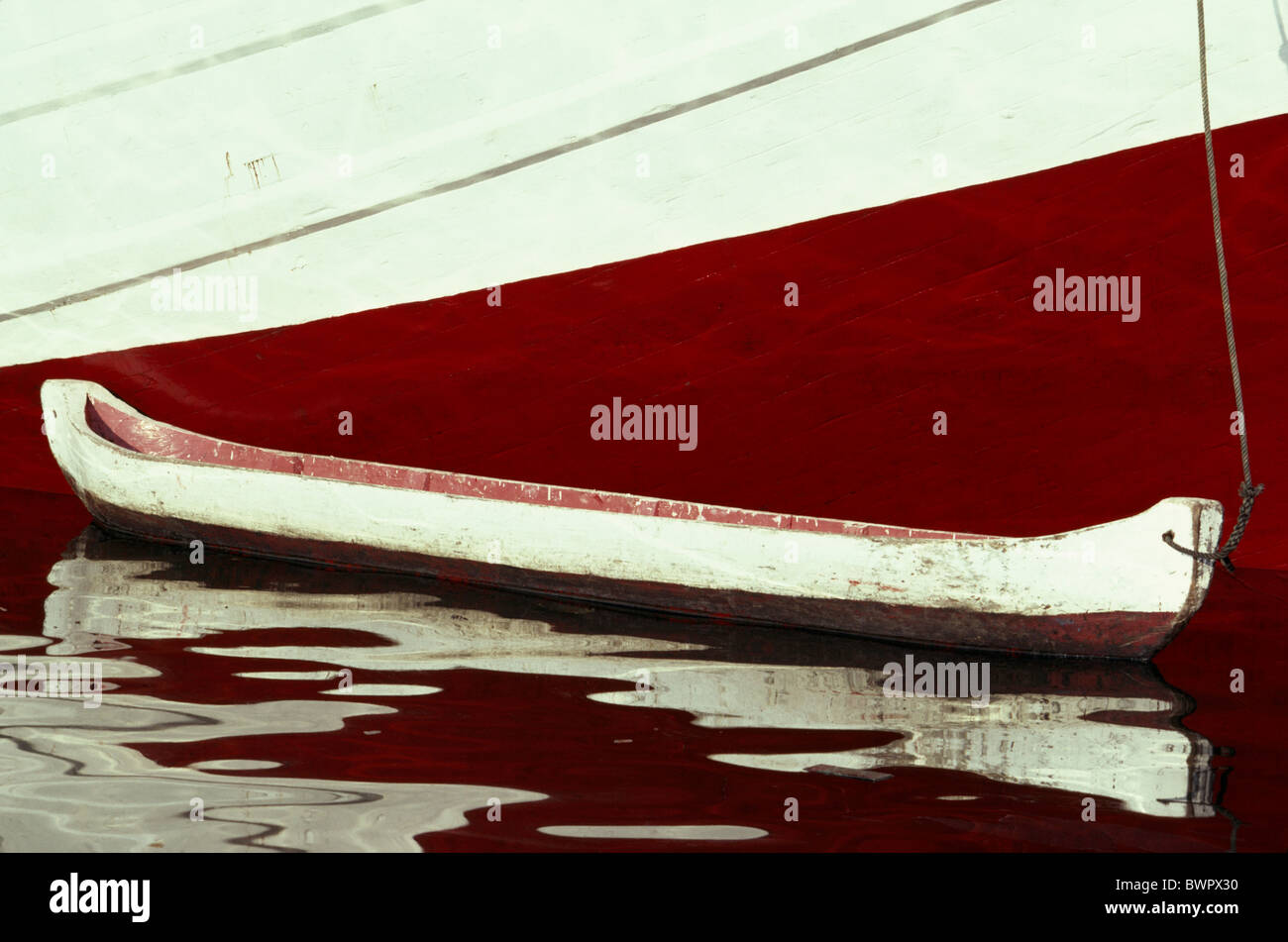 A pirogue (dugout canoe) tied up to a Macassar schooner at the fishing ...