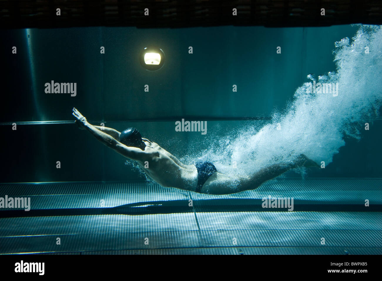 professional swimmer underwater after the jump on swimming pool Stock ...