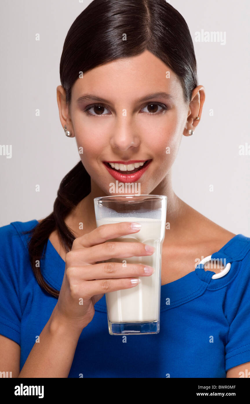 Portrait of a young women drinking a glass of milk Stock Photo - Alamy