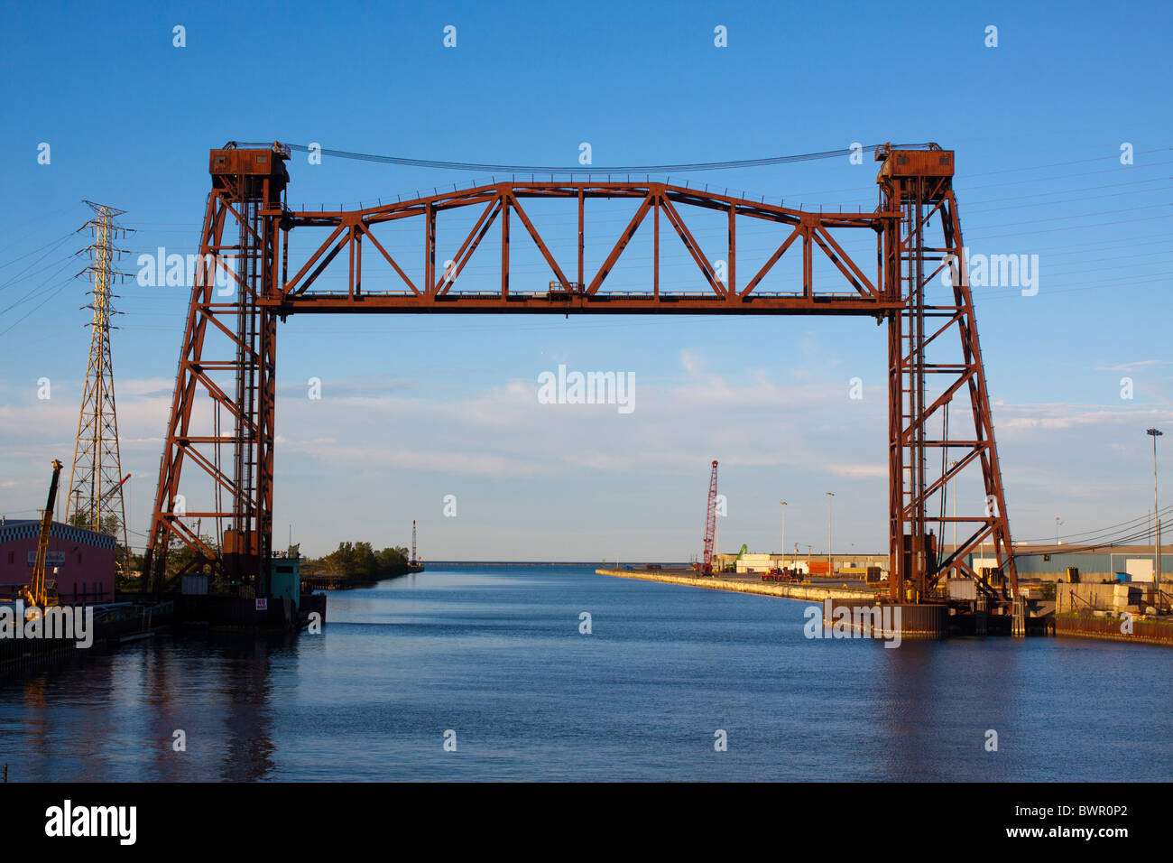 A railroad drawbridge is raised high over the Calumet River to allow ...