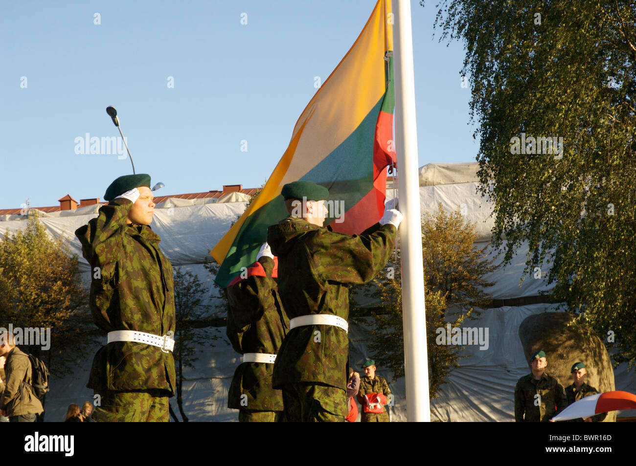 Lithuanian soldiers partake in a ceremony of raising the national flag ...