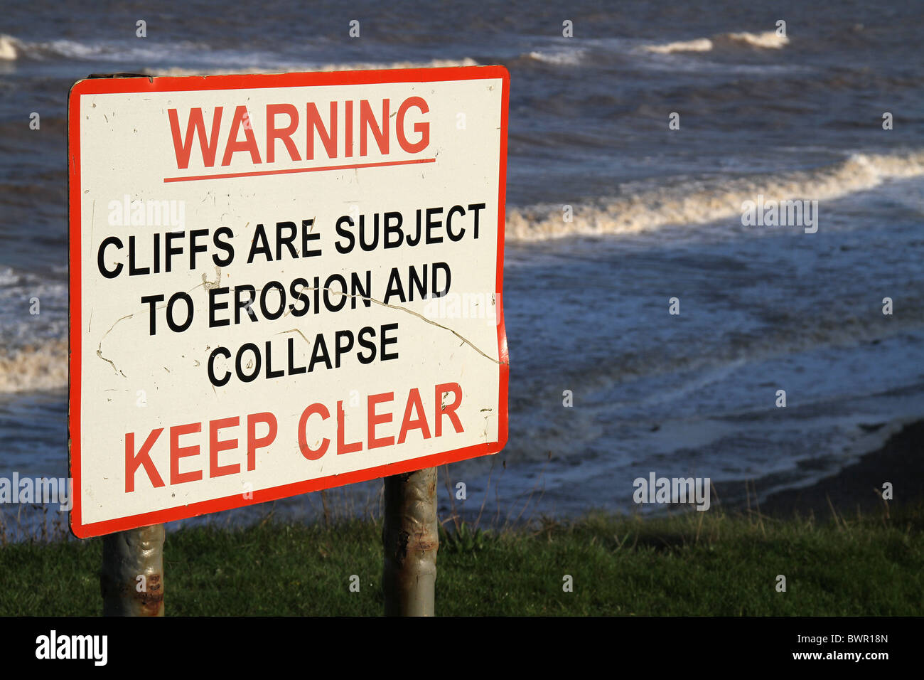 Cliff danger erosion warning sign Stock Photo - Alamy