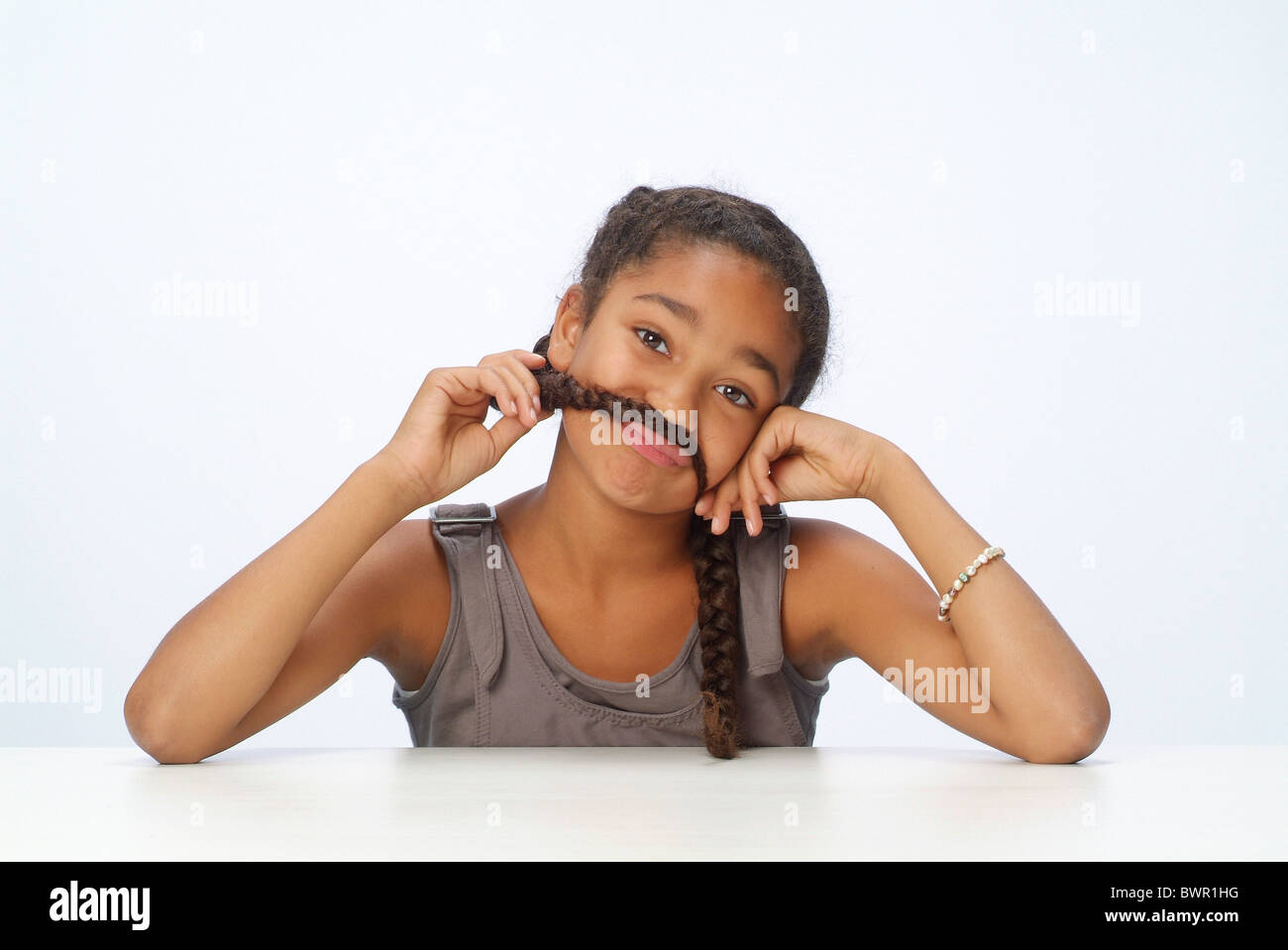 Portrait of a girl playing with her hair Stock Photo - Alamy