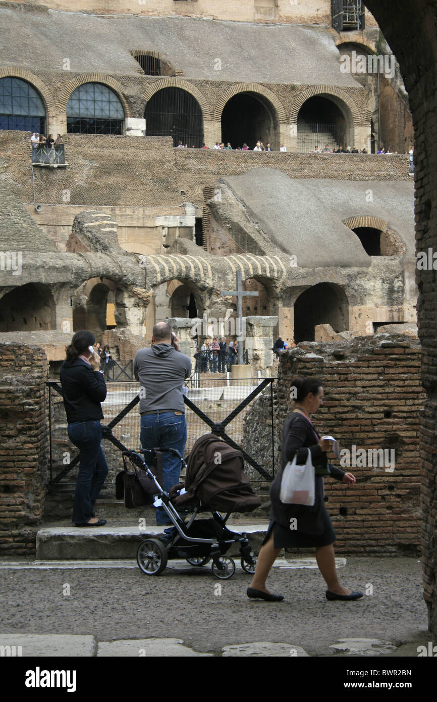 people in the colosseum amphitheatre wall facade, rome Stock Photo - Alamy