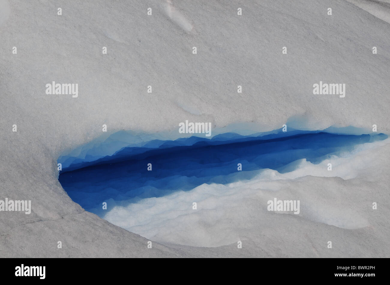 Close-up view of a horizontal, blue fissure crevasse in the sloping ...