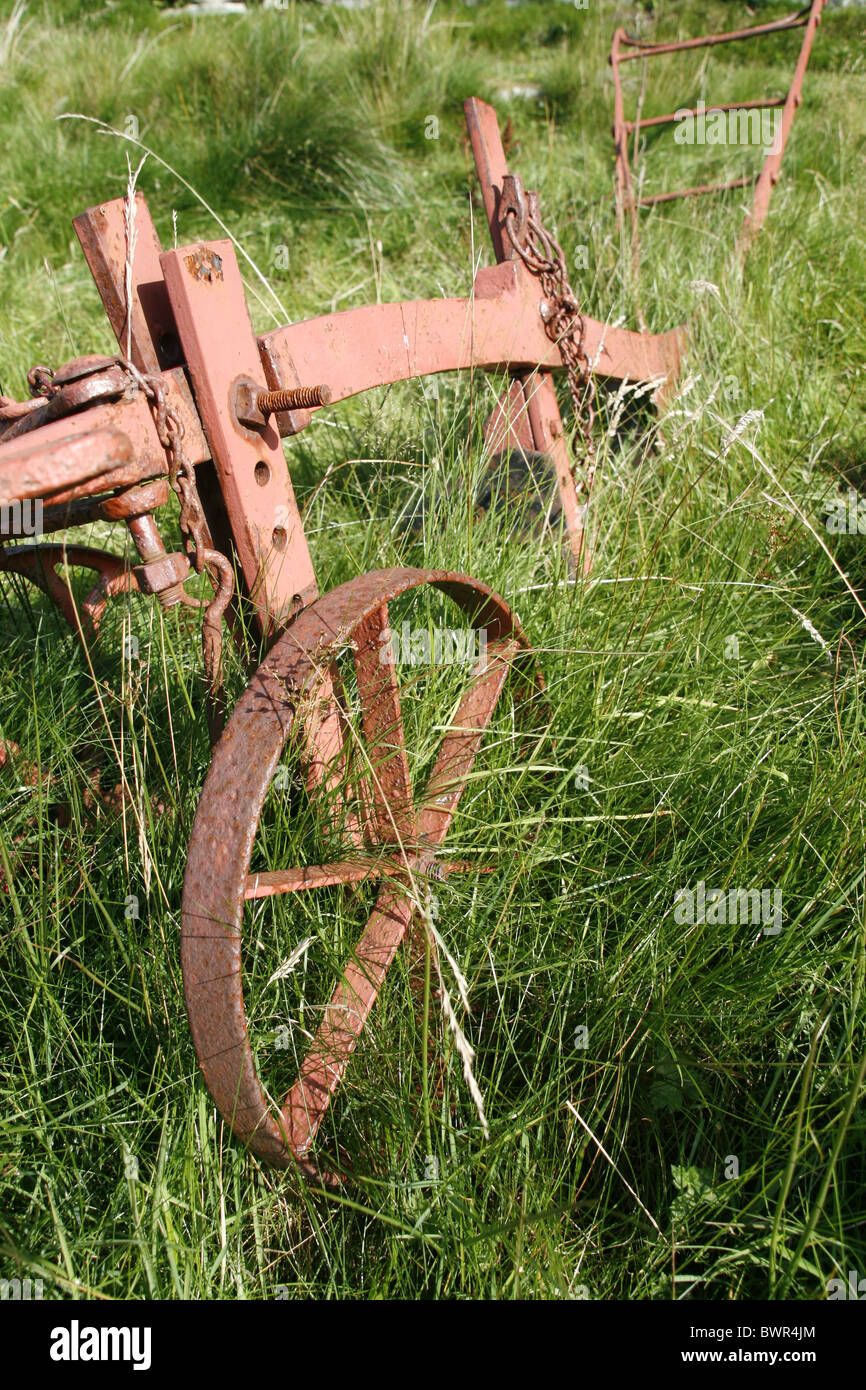 old ploughing equipment in field in wales great britain Stock Photo - Alamy