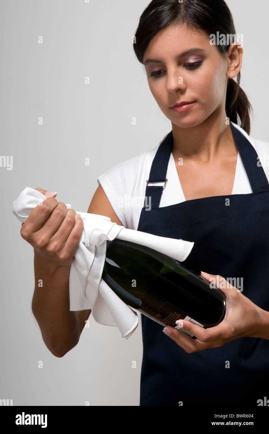 Waitress opening a champagne Stock Photo - Alamy