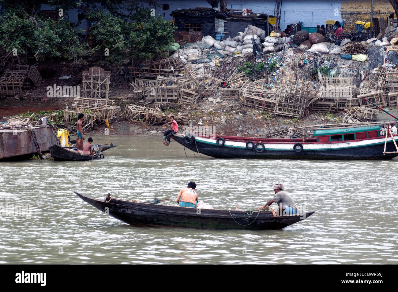 A riverside landing stage for fishing boats beside the Hooghly river ...