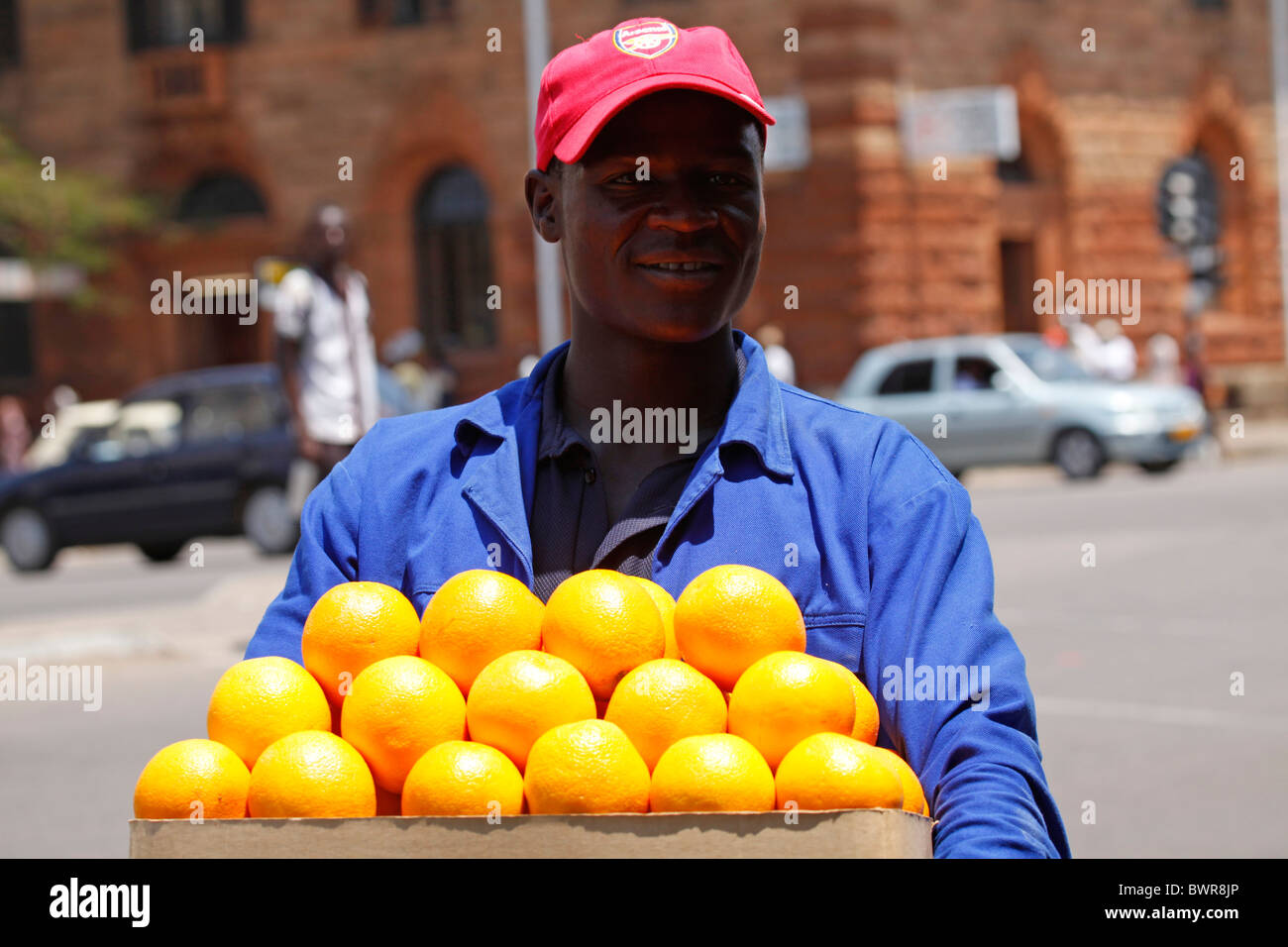 A Zimbabwean man in carries oranges in Bulawayo, Zimbabwe Stock Photo ...