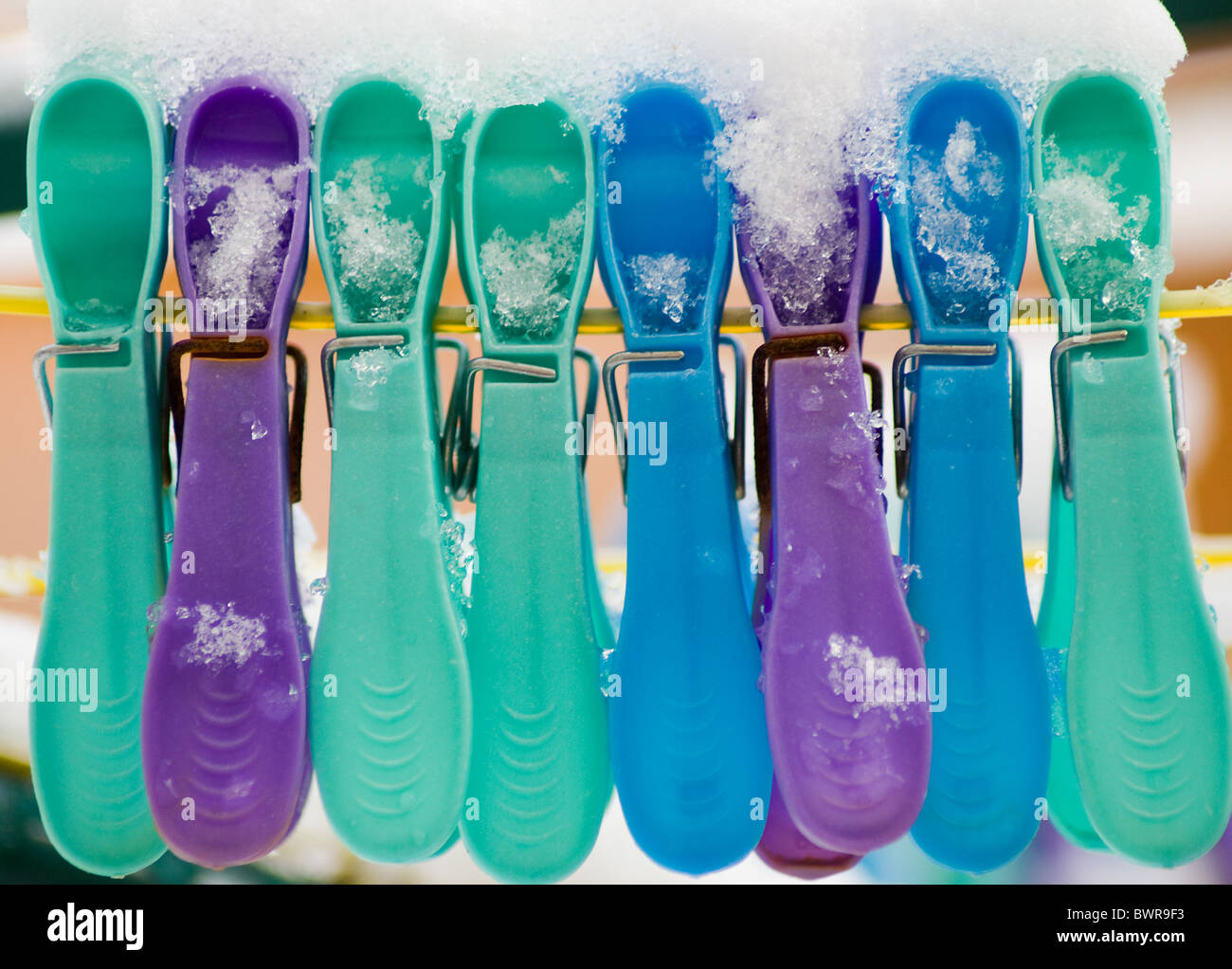 Pegs covered in snow Stock Photo - Alamy