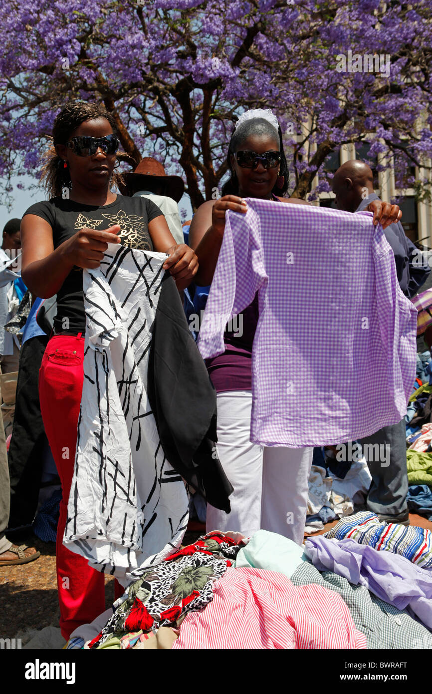 Women examine clothes at the so-called "bend down market" in Bulawayo ...