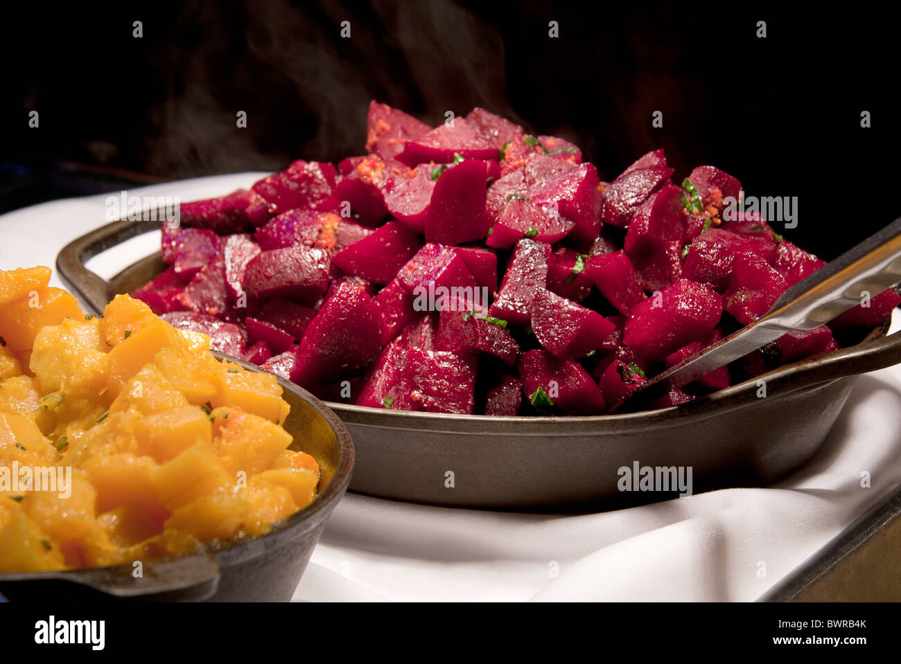 Cooked beets and sweet potatoes on a buffet table Stock Photo - Alamy