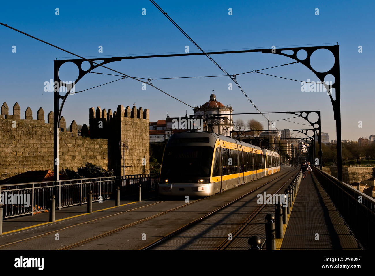 Train over the bridge next to medieval wall in Porto, Portugal Stock ...