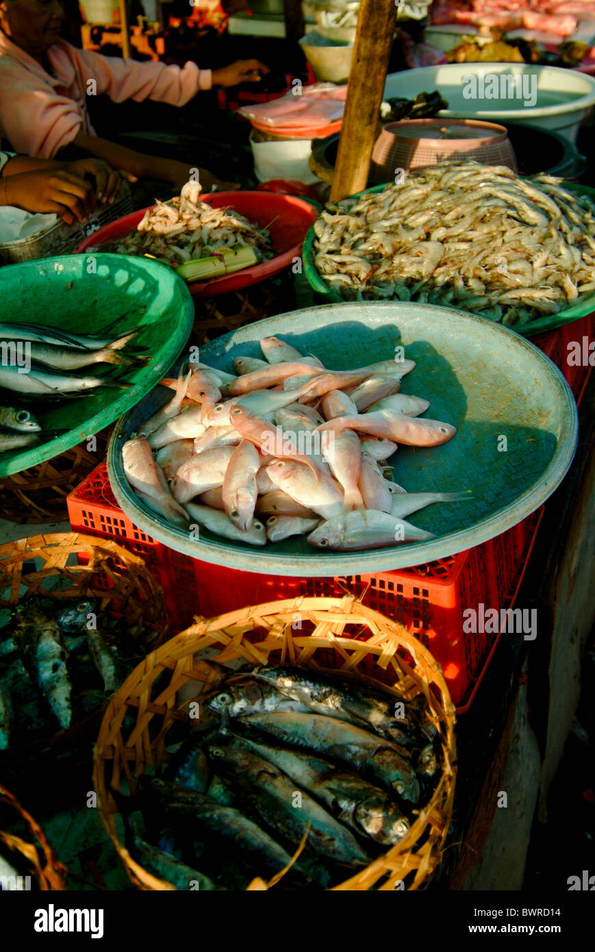 In a small village traditional market in Bali, Indonesia, sellers lay ...