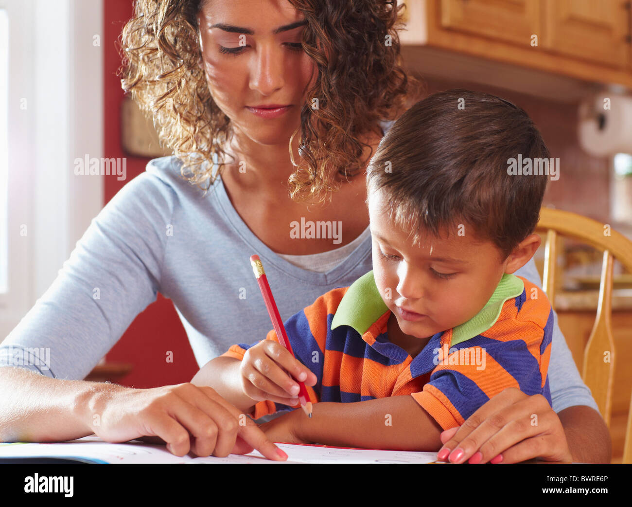 Mother helping son with homework Stock Photo - Alamy